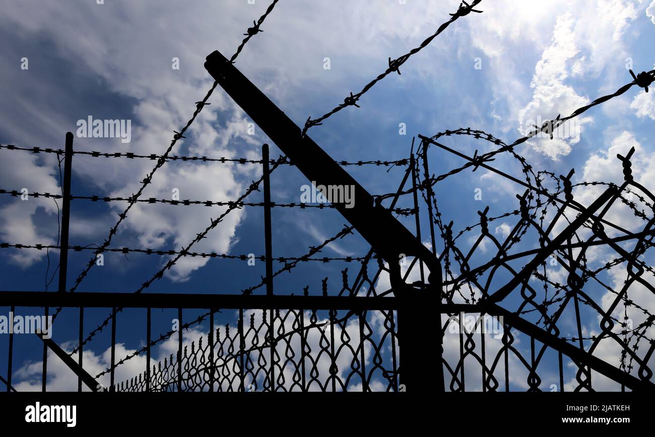 Сontour of barbed wire on background beautiful clouds and sky Stock ...