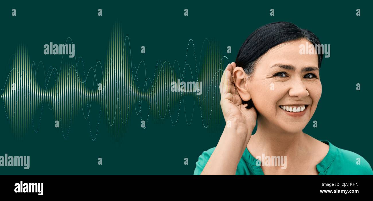 Positive woman with hand near ear and with luminous sound wave on green ...