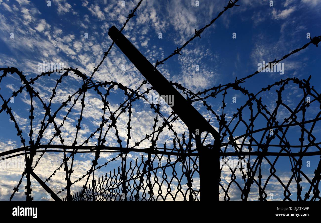 Сontour of barbed wire on background beautiful clouds and sky Stock ...