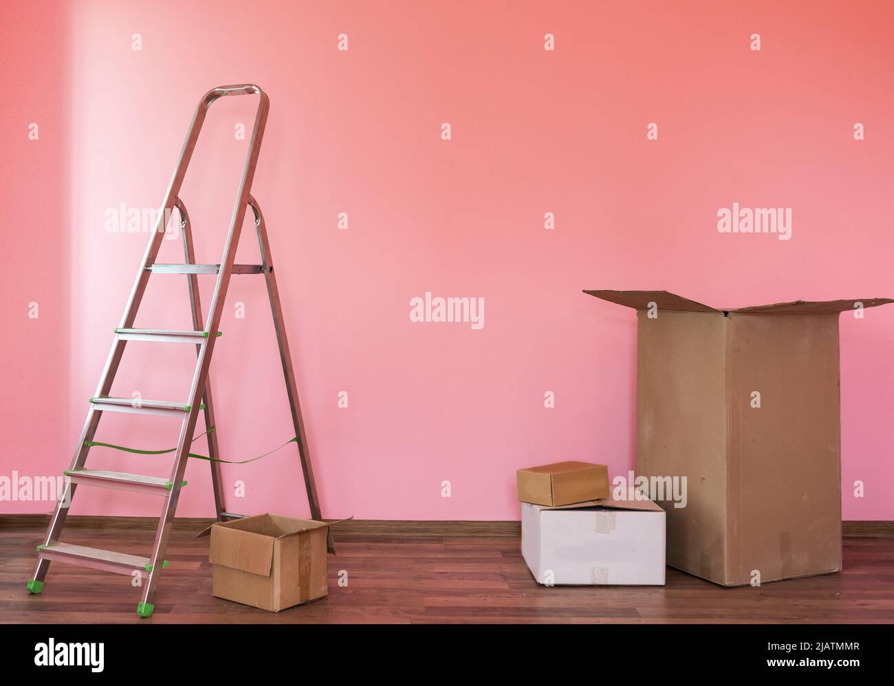 Foldable chrome stepladder against blank wall indoors Stock Photo - Alamy