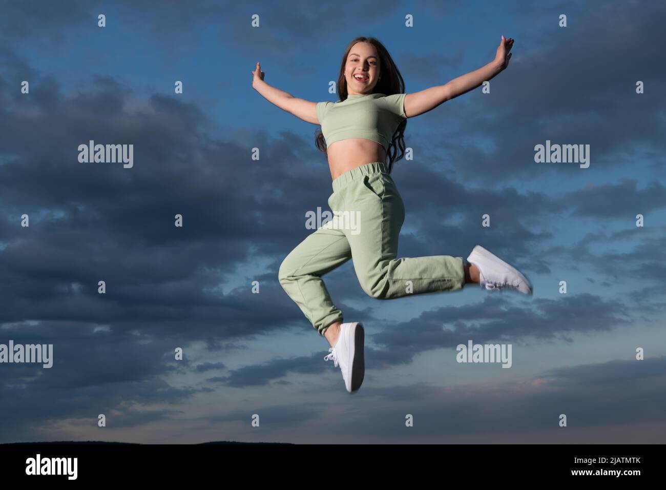 happy teen girl jump high on sky background Stock Photo - Alamy