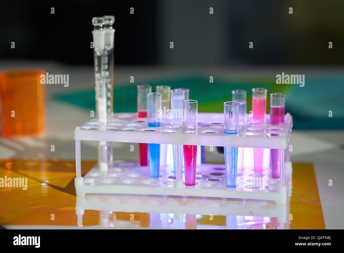 Solution in a scientific glass flask against the background of a school ...