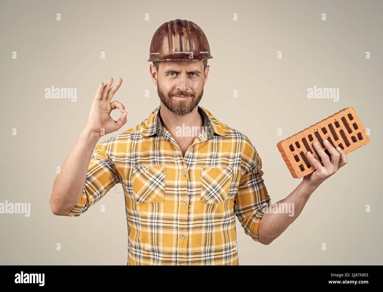 professional bricklayer show ok gesture. builder engineer. labor or ...