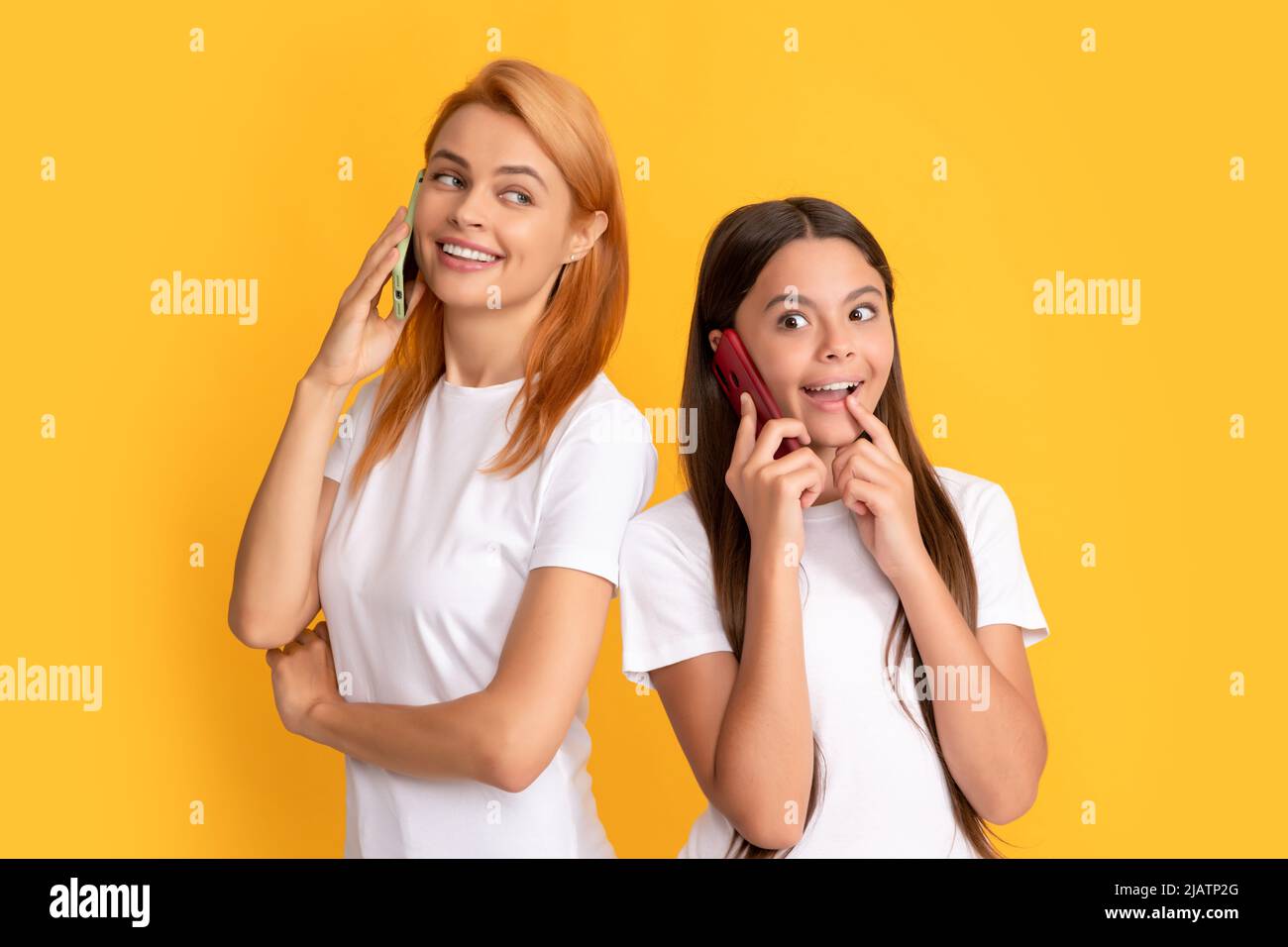 mother and daughter speaking using modern smartphone, communication ...