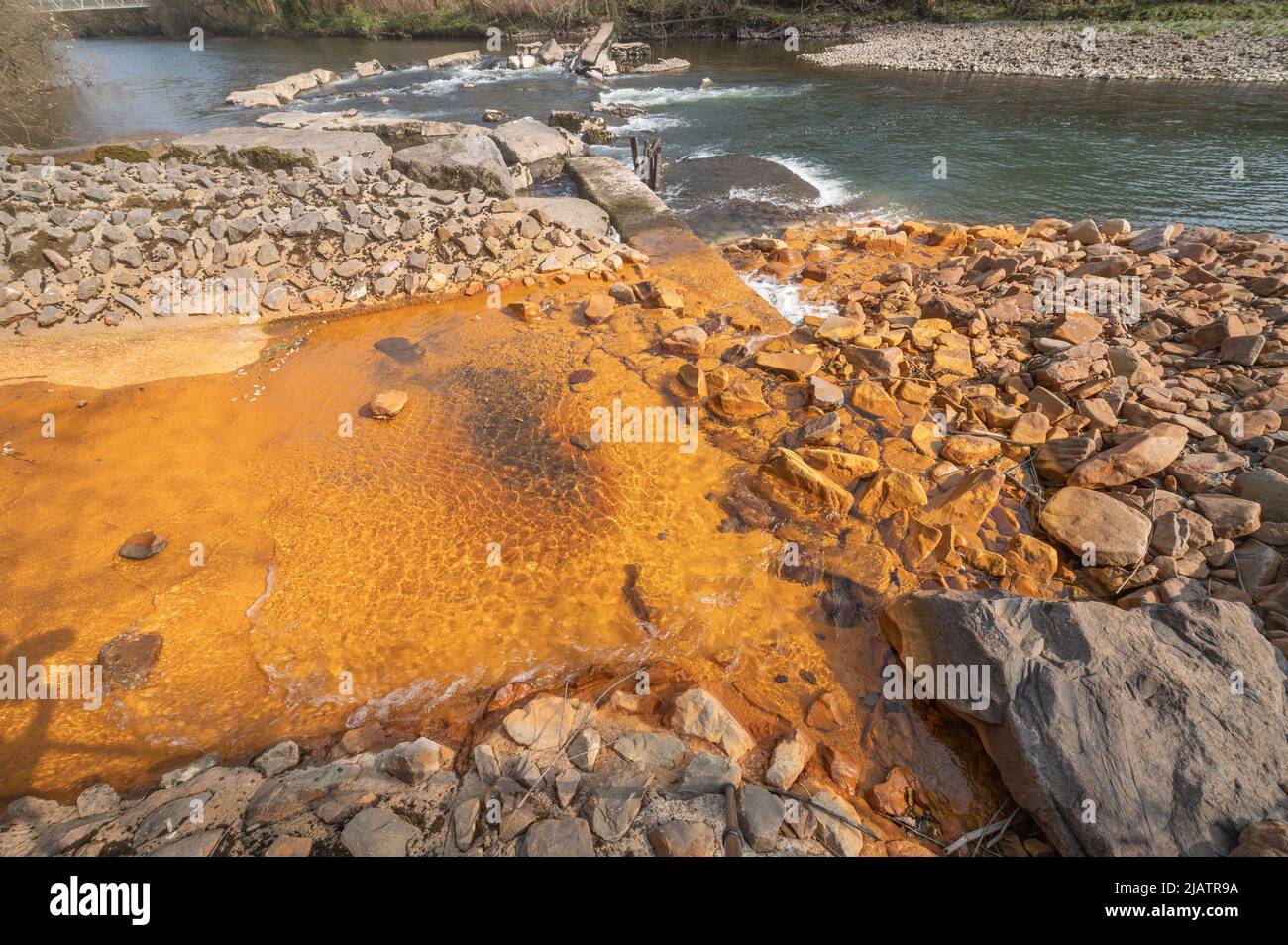 Orange iron oxide staining in stream, River Neath, Wales Stock Photo ...