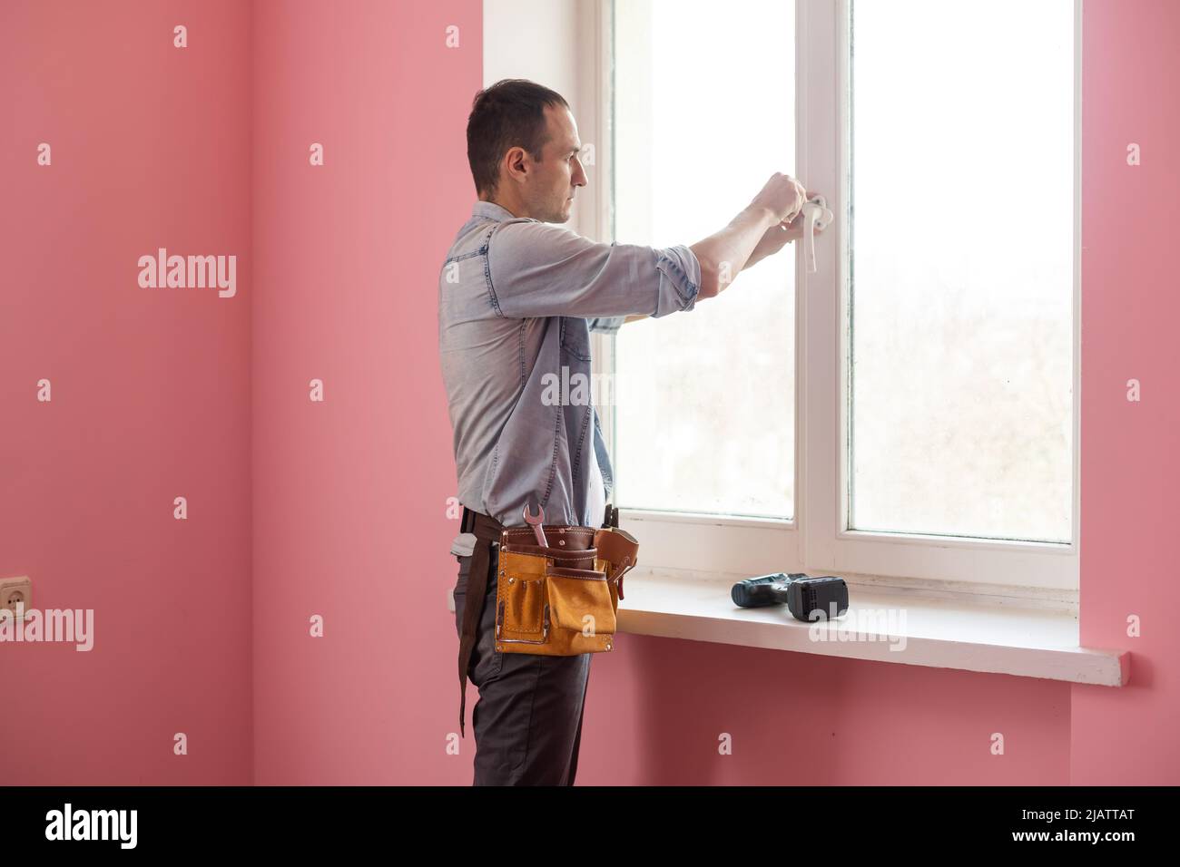 Worker installing checking window hi-res stock photography and images ...
