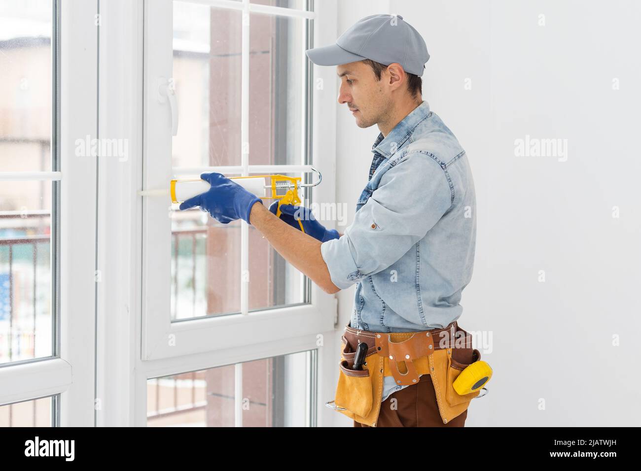 The worker installing and checking window in the house Stock Photo - Alamy
