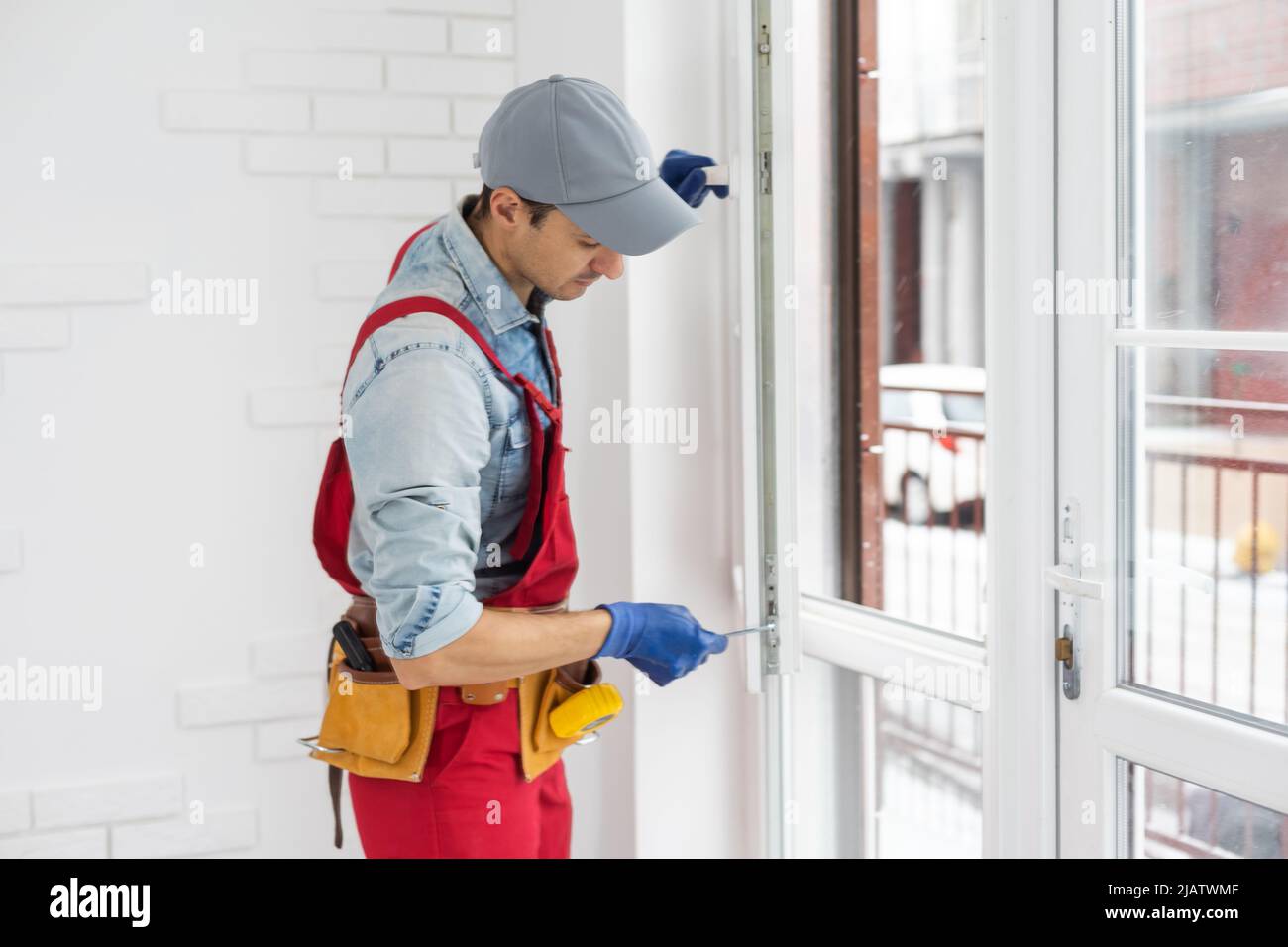 The worker installing and checking window in the house Stock Photo - Alamy