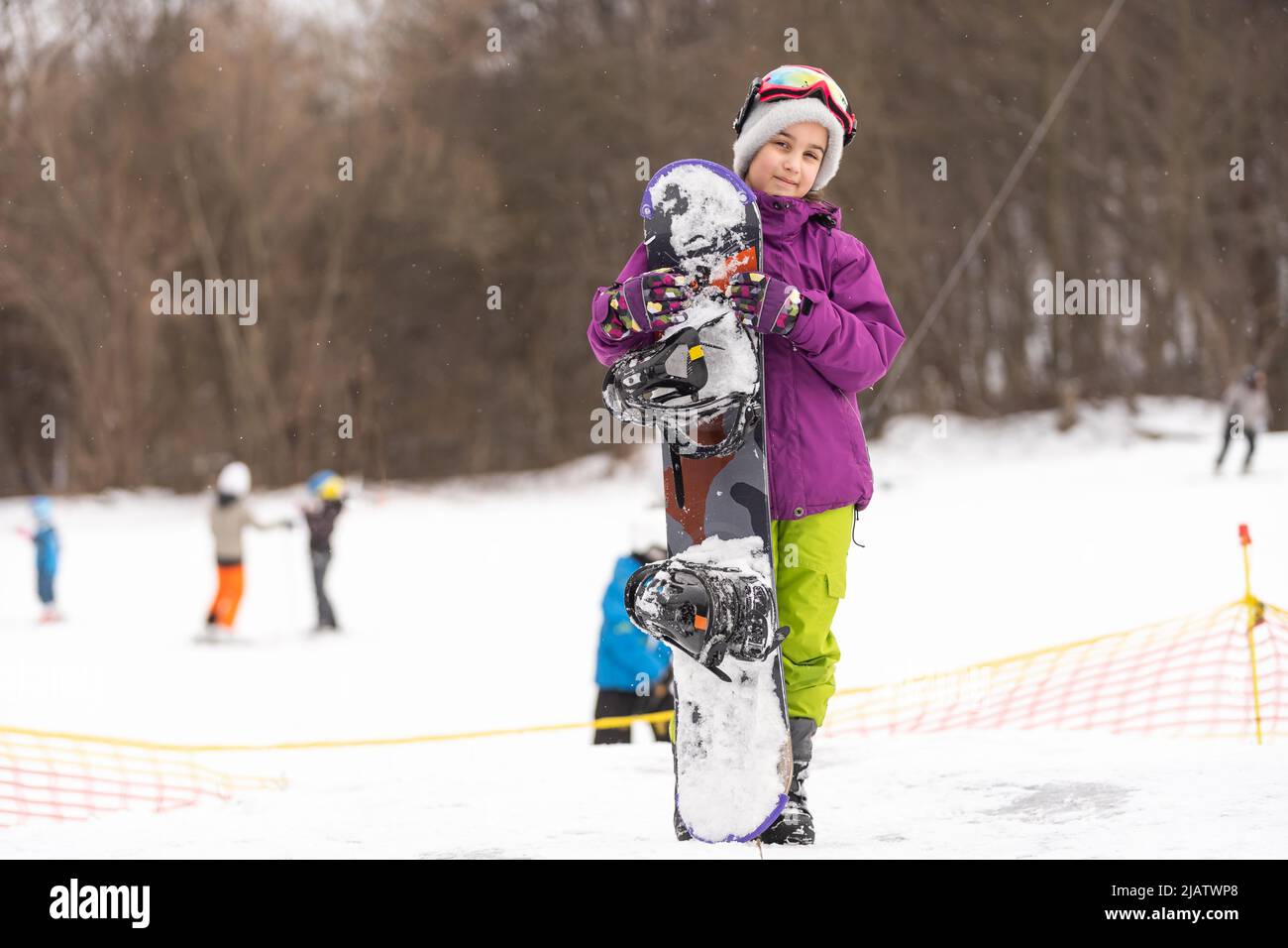 Little Cute Girl Snowboarding at ski resort in sunny winter day Stock ...