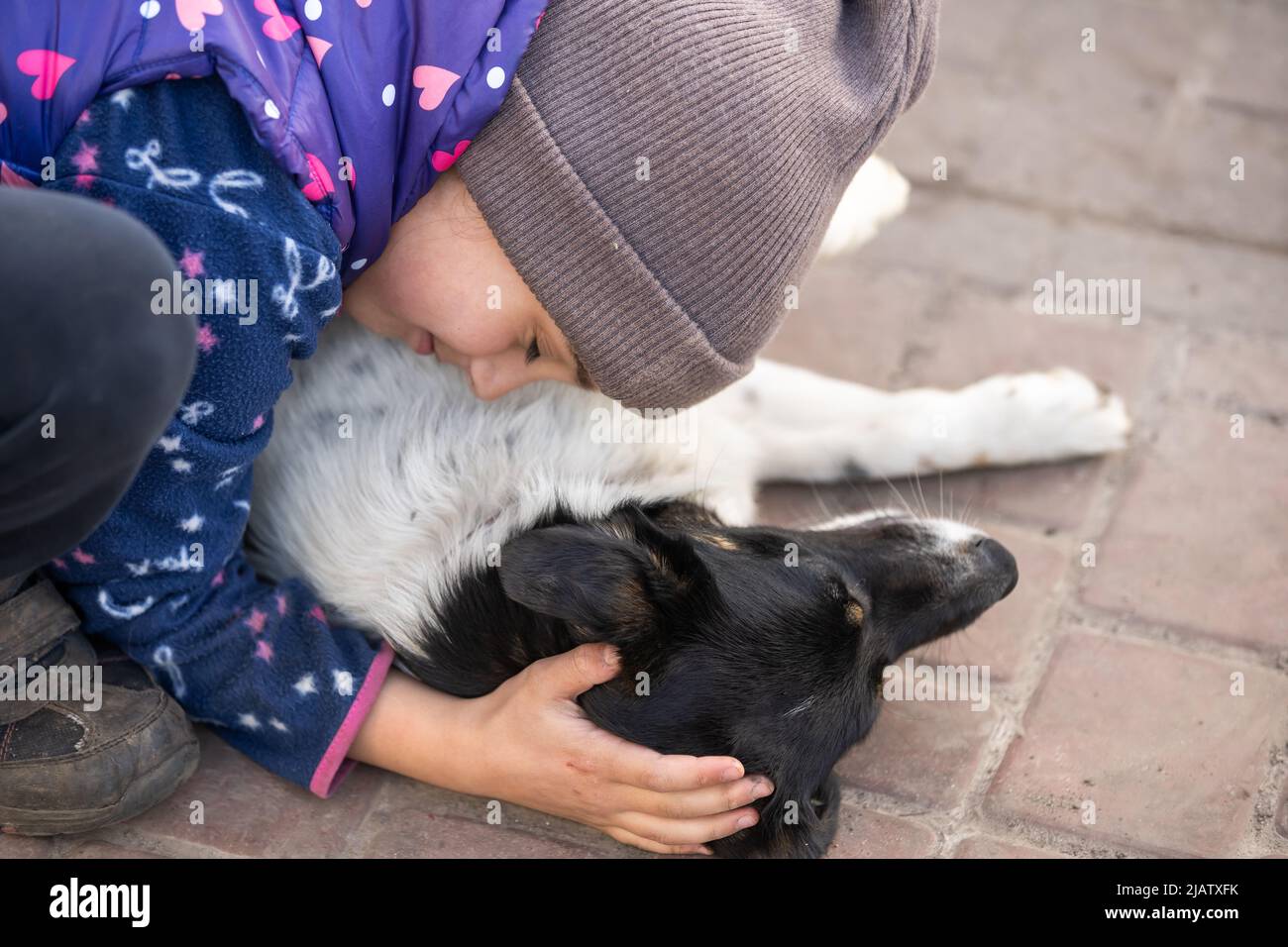 poor little girl with a dog in village Stock Photo - Alamy