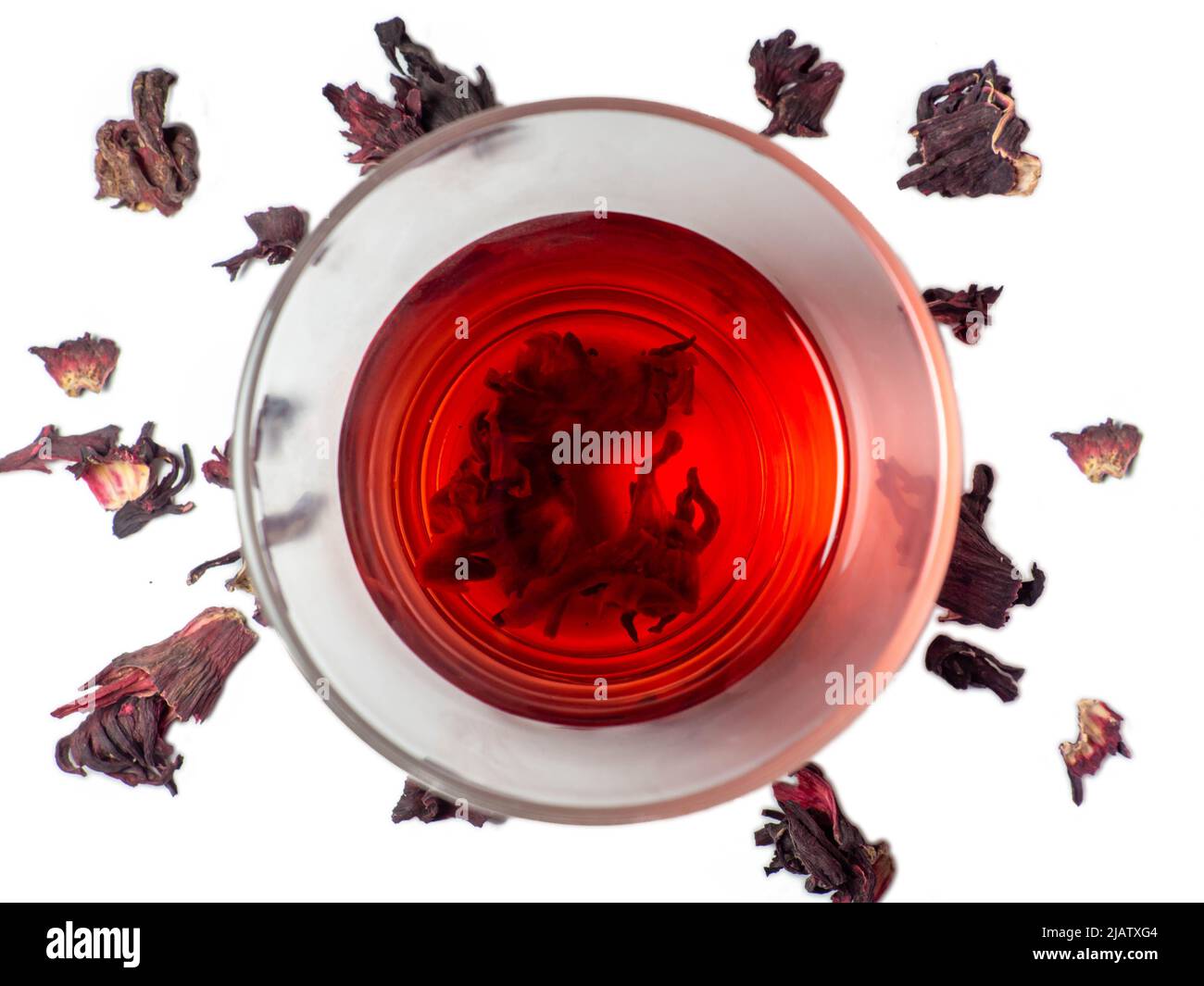 Karkade. Tea drink in a glass. Red liquid in a glass. Dried petals ...