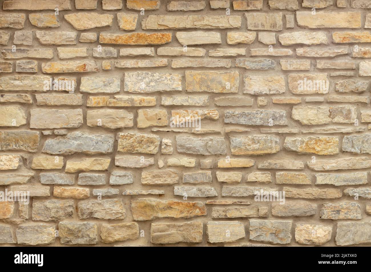 Solid yellow and beige stone wall. Stone background Stock Photo - Alamy