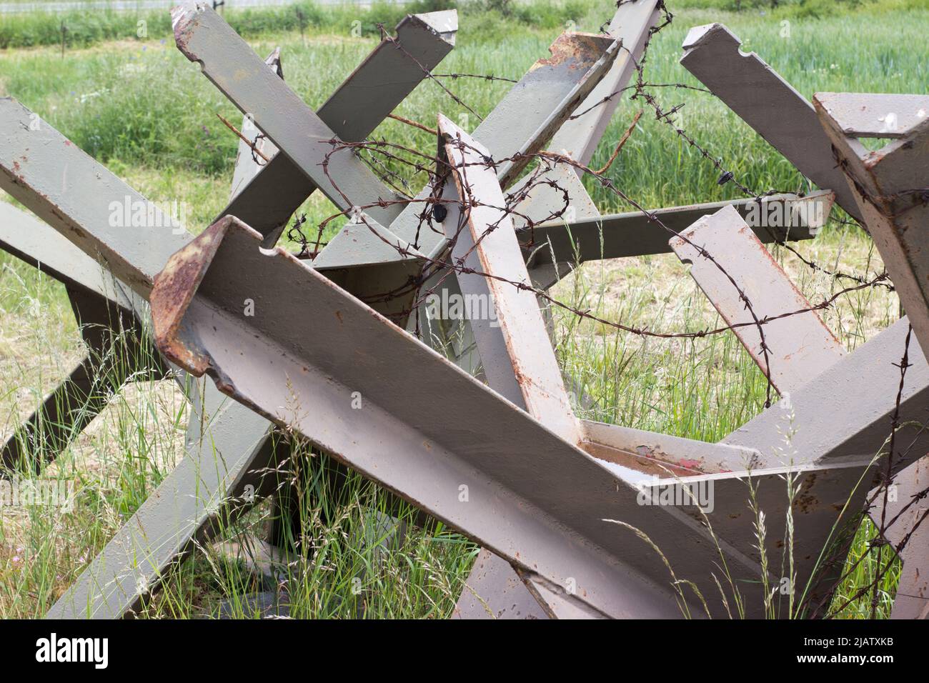 Hedgehod anti-tank barrier with rusty barbed wire Stock Photo - Alamy