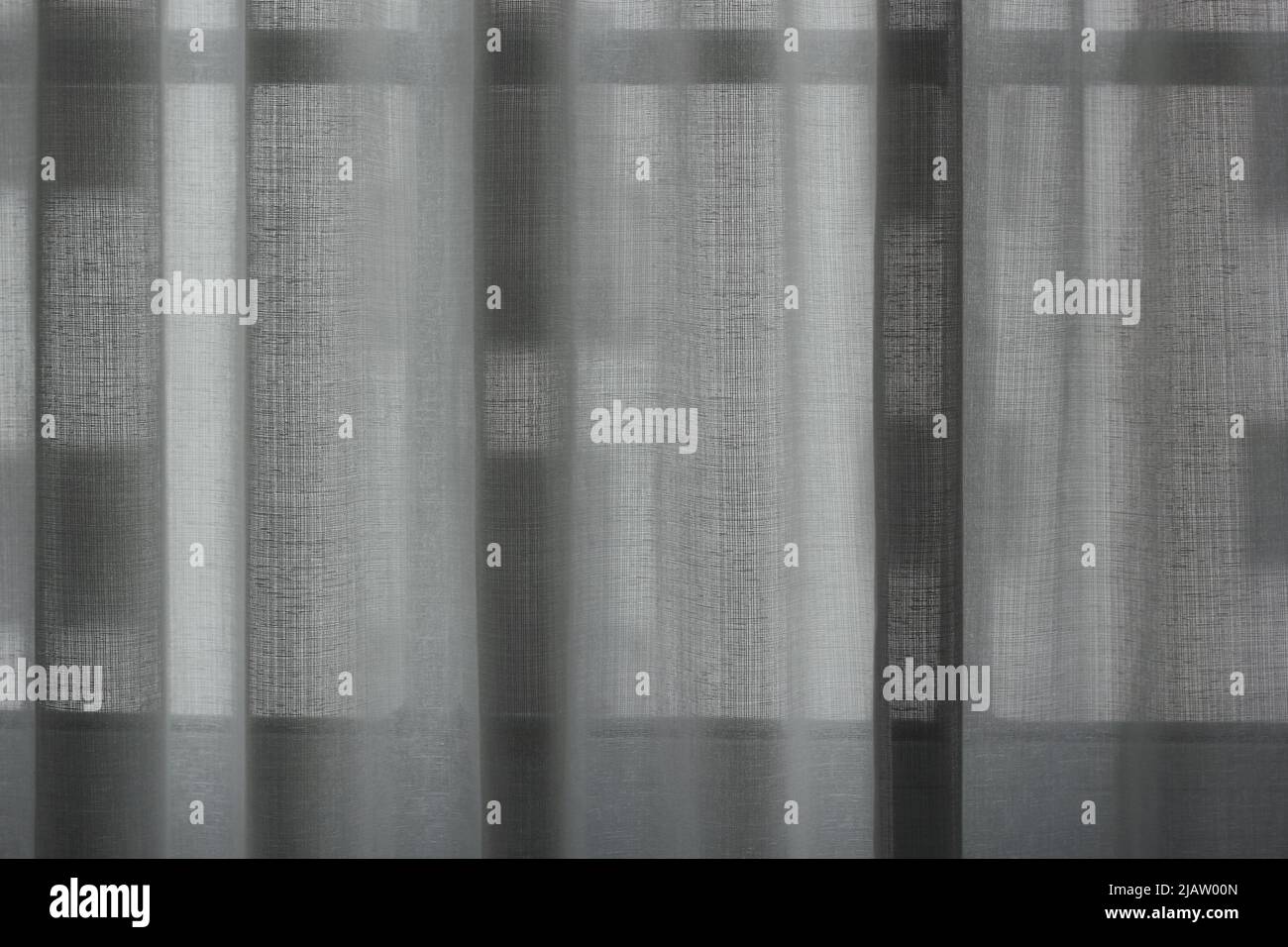 Full frame view of white cotton curtains hanging front o& a window ...