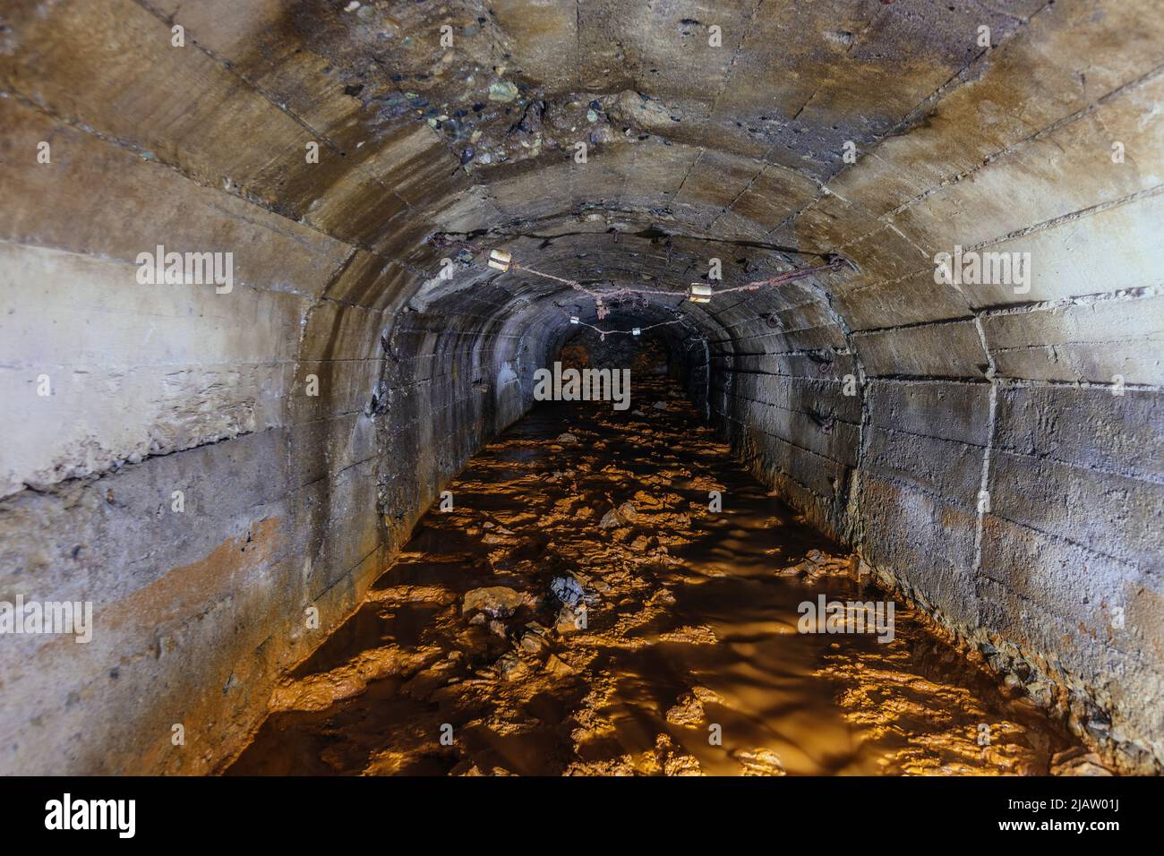Dark dirty flooded collapsed mine tunnel Stock Photo - Alamy