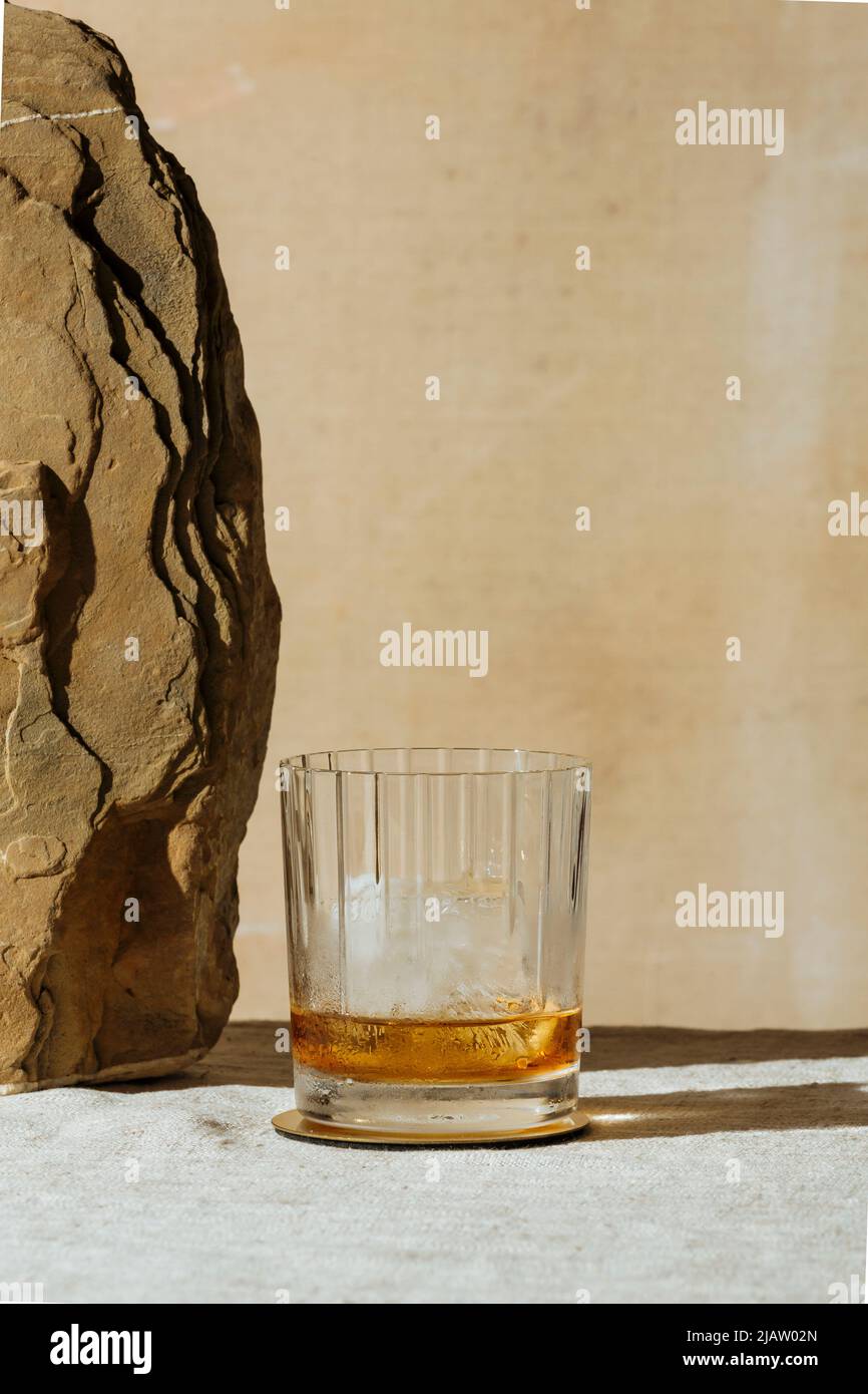 Whiskey glass and a rock, still life as an equivalence for flavor Stock ...