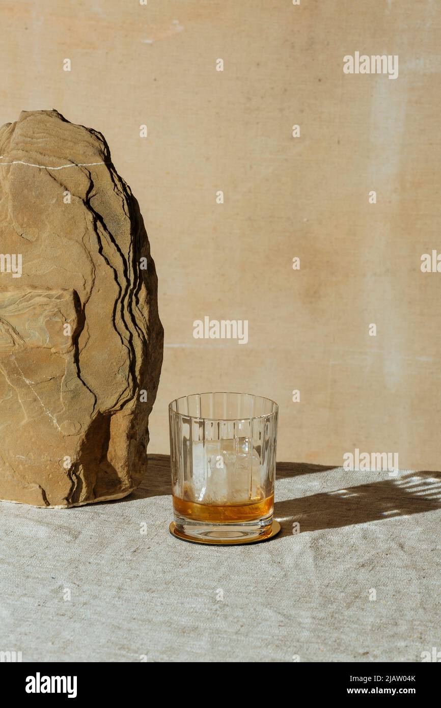 Whiskey glass and a rock, still life as an equivalence for flavor Stock ...