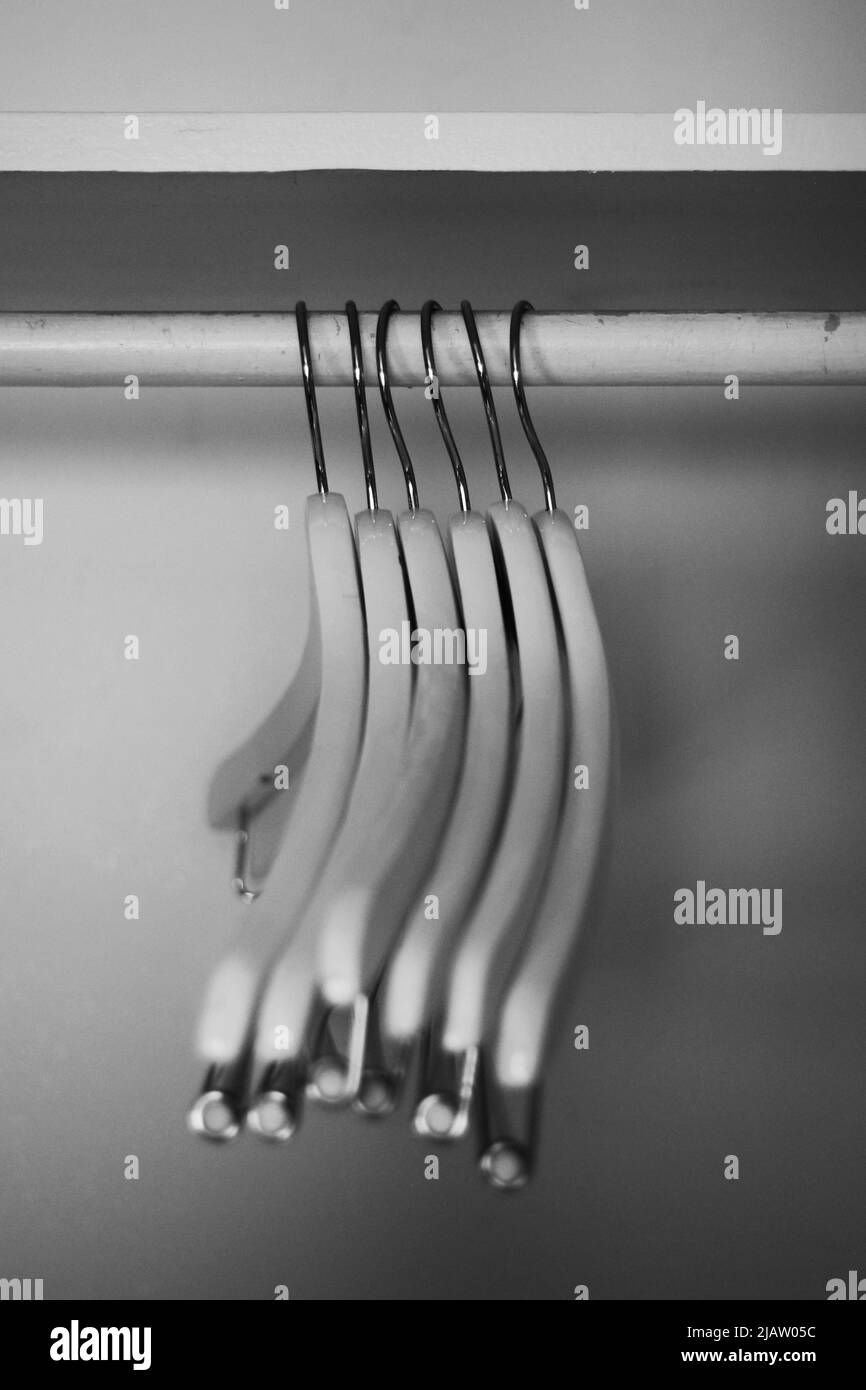 Typical empty clothes hangers hanging in the bedroom closet in black ...
