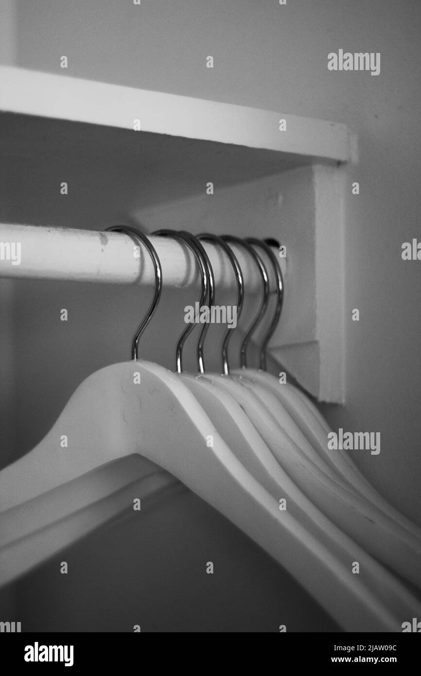 Wooden hangers in empty closet Black and White Stock Photos & Images ...