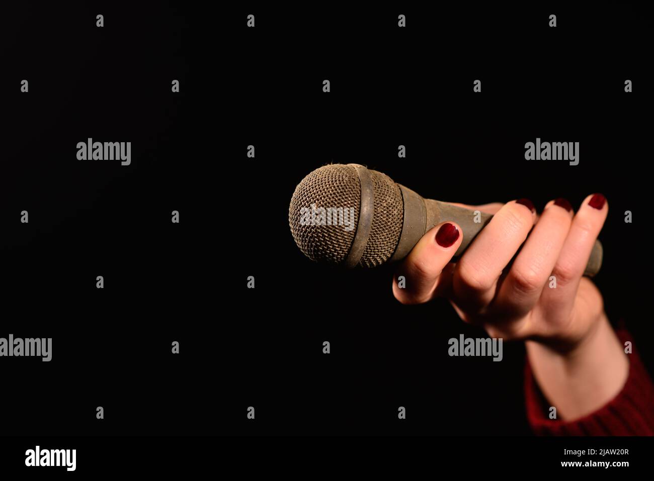 girl holding dirty microphone Stock Photo - Alamy