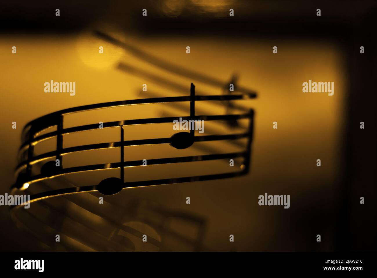 music notes on dark yellow background Stock Photo - Alamy