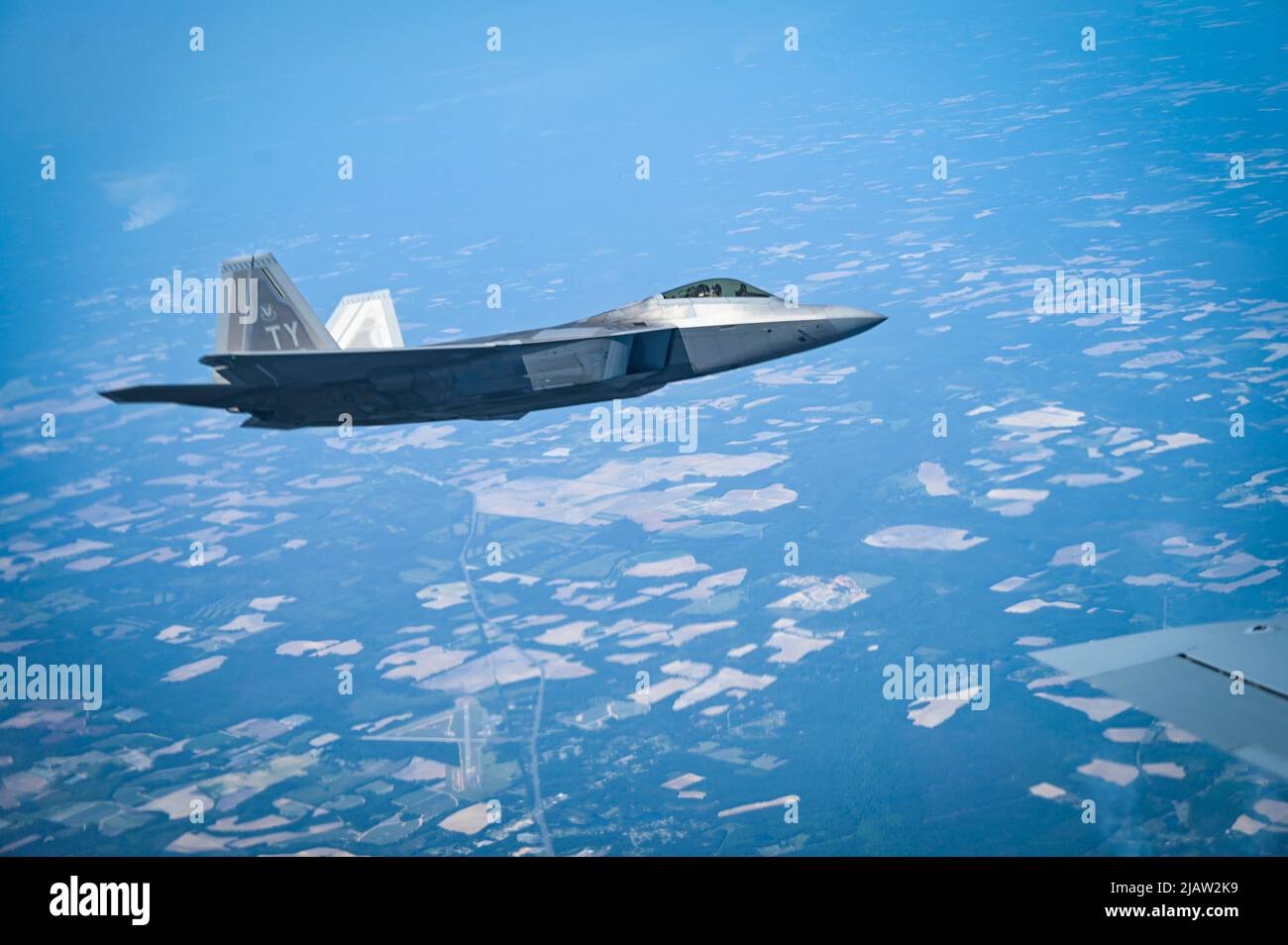 A U.S. Air Force F-22 Raptor with the 325th Fighter Wing, approaches a ...
