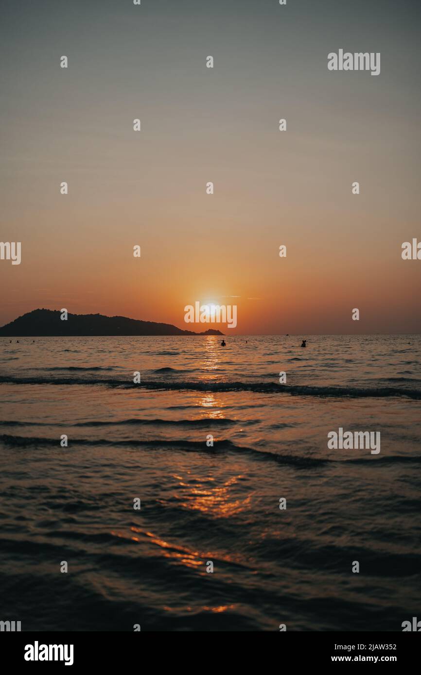 Sunset glowing in the waves of a beach in Phuket, Thailand Stock Photo ...
