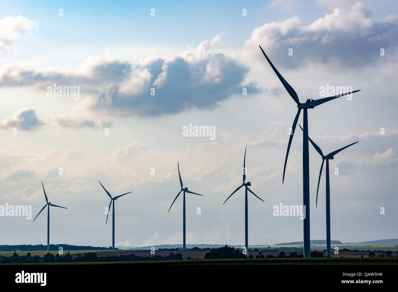 Wind turbines with clouds and blue skies in France near Paris during ...