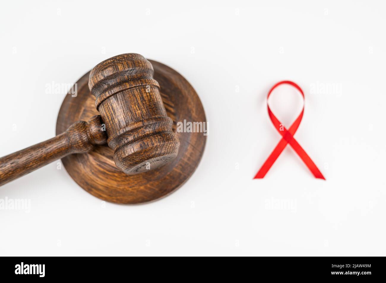 Judicial gavel and red ribbon on a white background. Symbol of the ...
