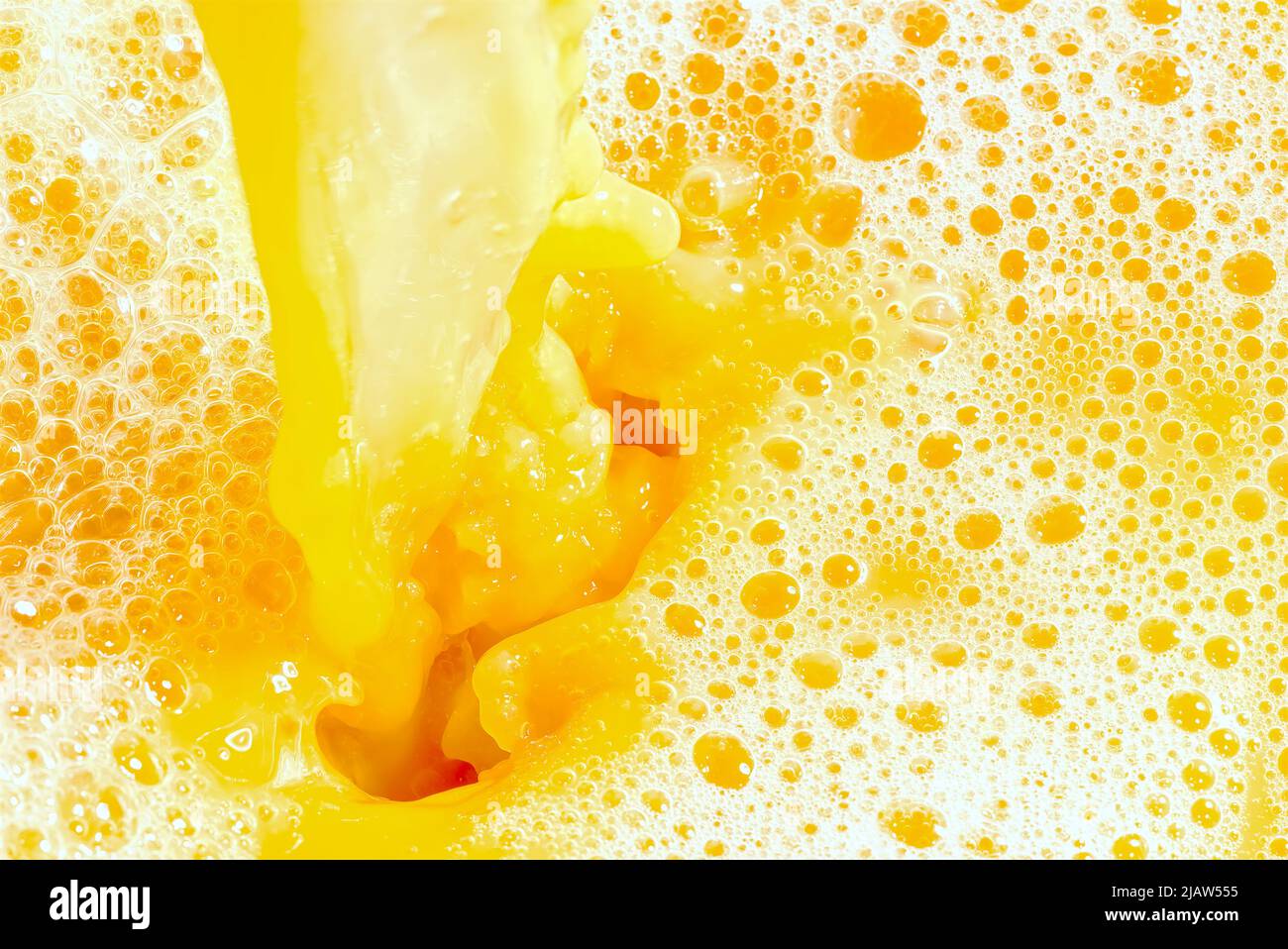 Closeup of splashing orange juice, top view. Splash of fresh sweet ...