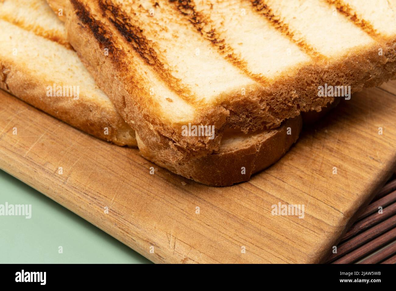 loaf of bread toast on top of wooden board and green background Stock ...