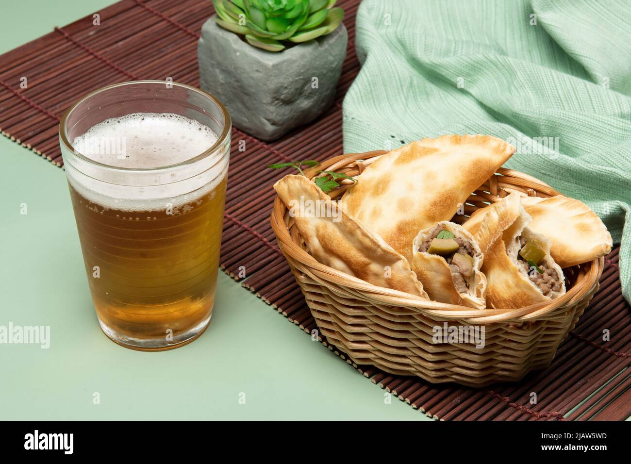 portion of bar meat pastries in a green background Stock Photo - Alamy