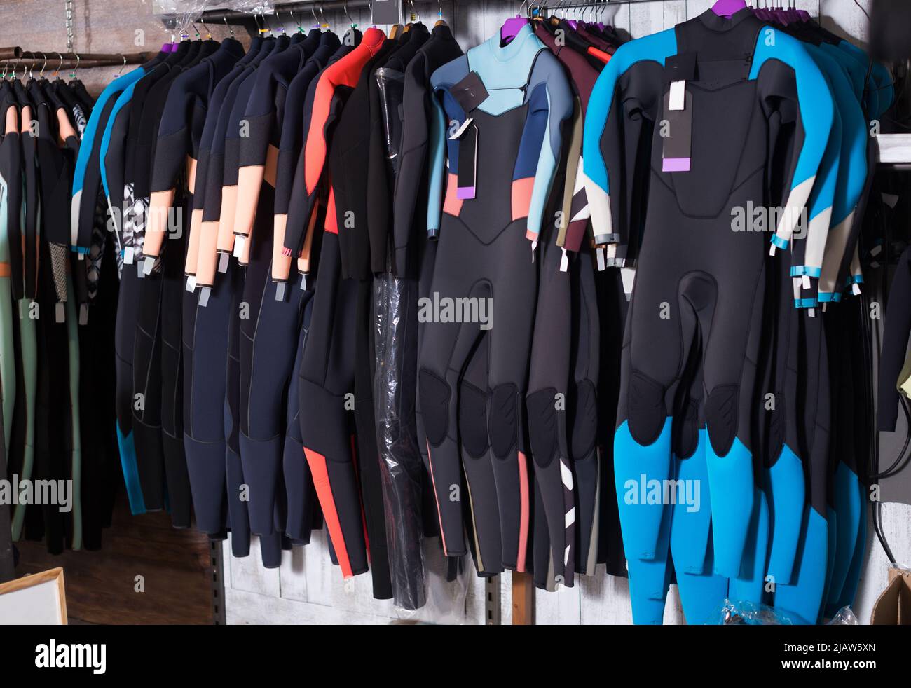 Image of colorful wetsuit hanging in the store for surfing Stock Photo ...