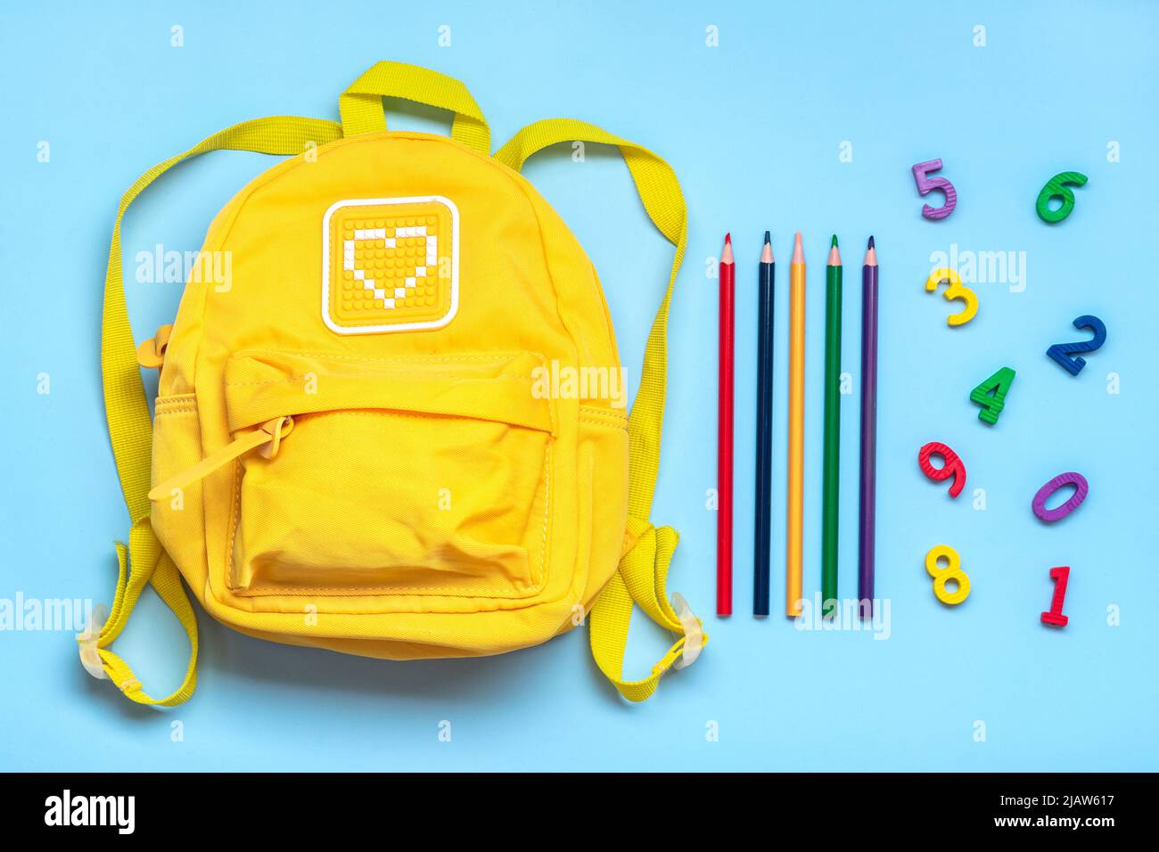 Back to school, education concept. Yellow backpack, pencils, numbers ...