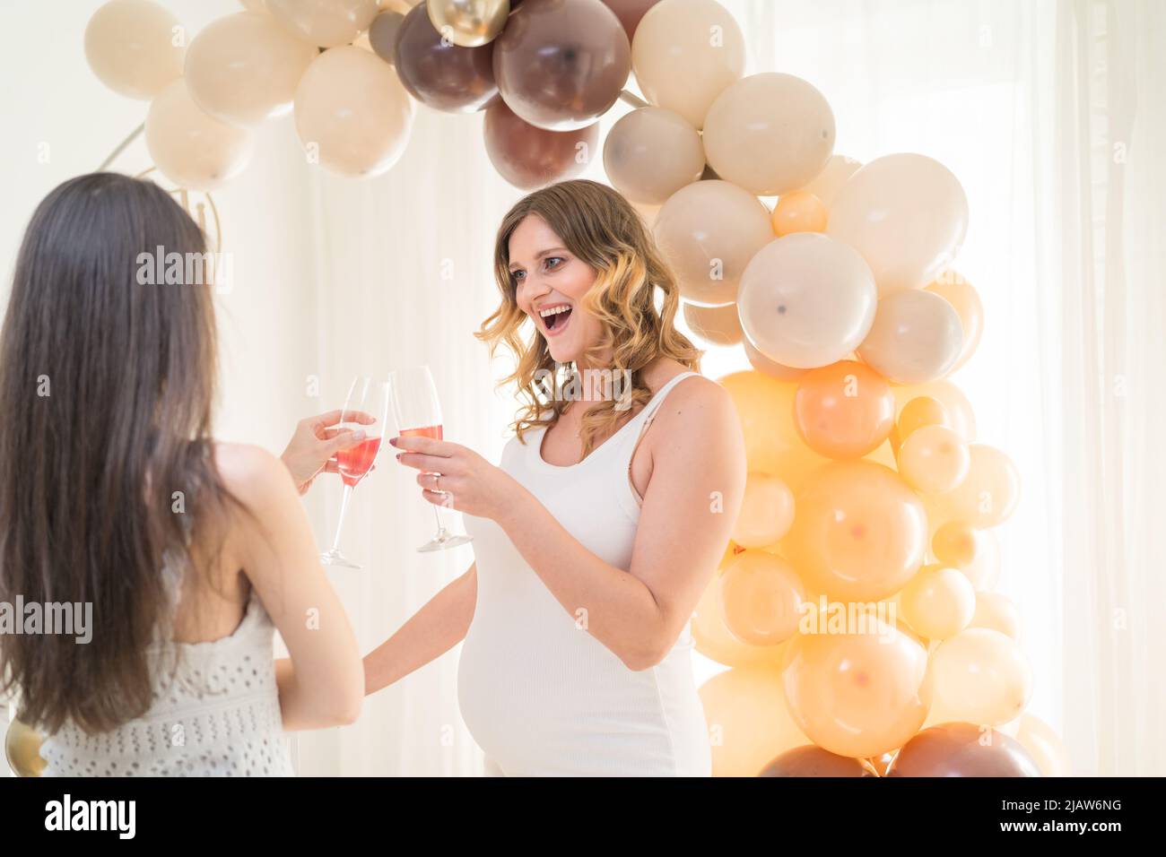 Happy woman celebrating with pink drink at baby shower party Stock ...