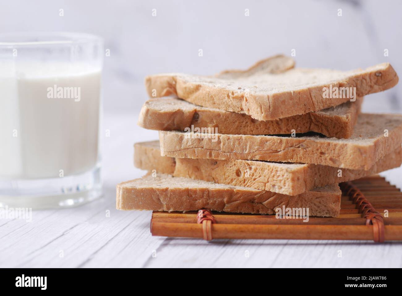 close up of stack of baked bread and glass of milk on table Stock Photo ...