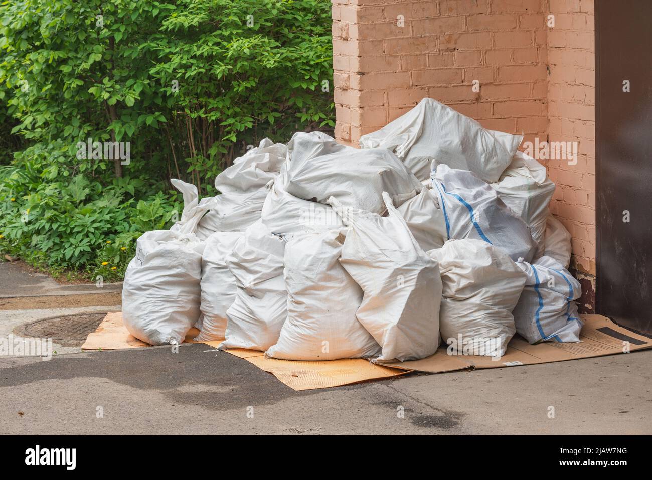 Construction waste in the bags before loading Stock Photo - Alamy