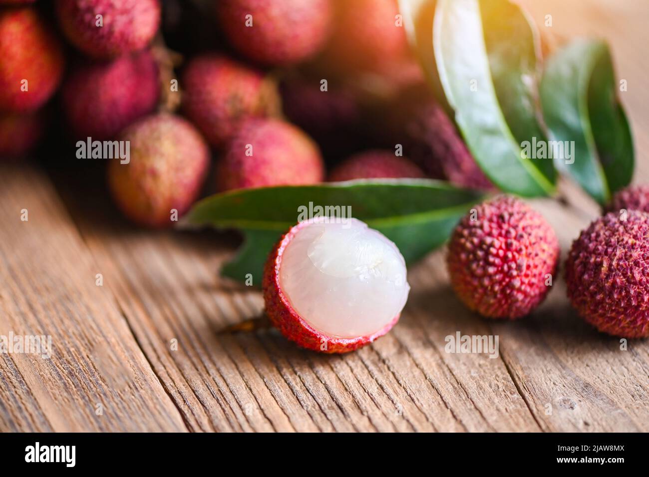 Lychee fruit and green leaf on wooden background, fresh ripe lychee ...