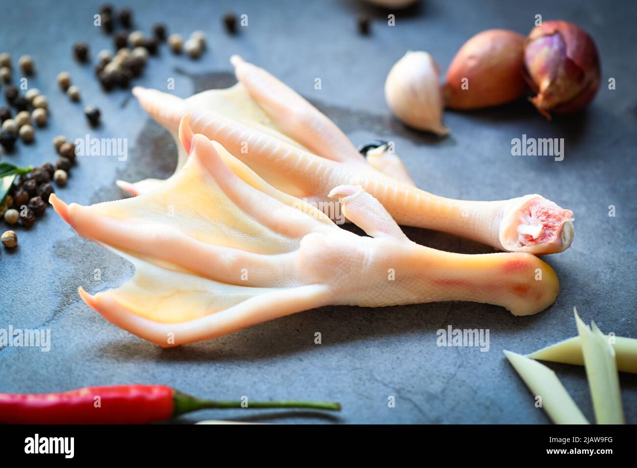 duck feet with herb spices ready to cook on plate, Fresh feet duck for ...