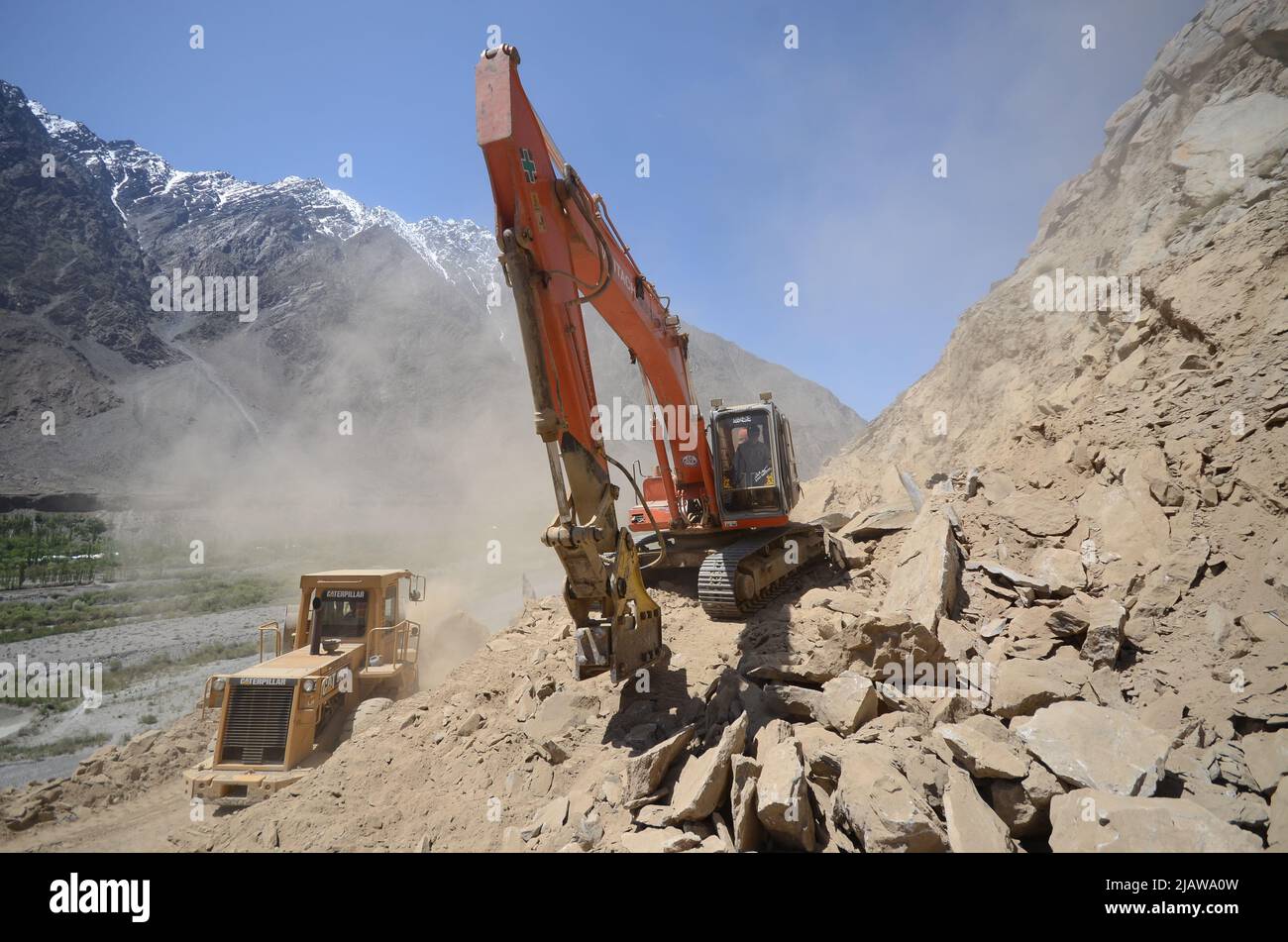 Construction workers work on the road in Peshawar, Pakistan on May 25 ...