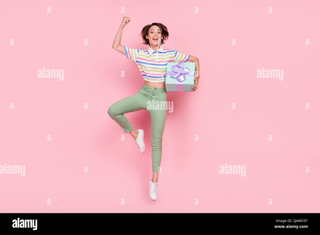 Full length photo of young girl celebrate success present box jump up ...
