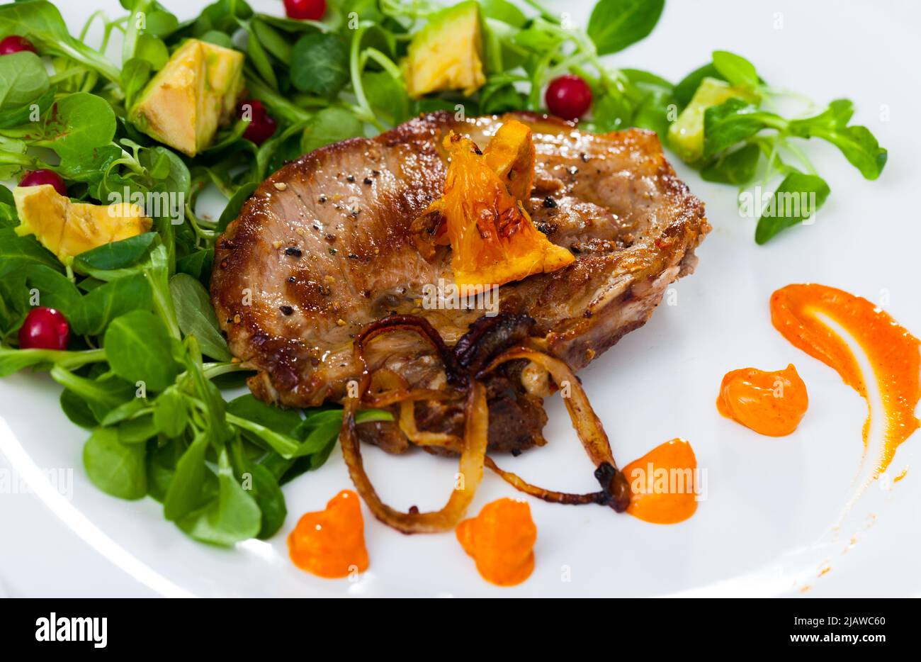 Grilled pork chop with greens and squash puree Stock Photo - Alamy