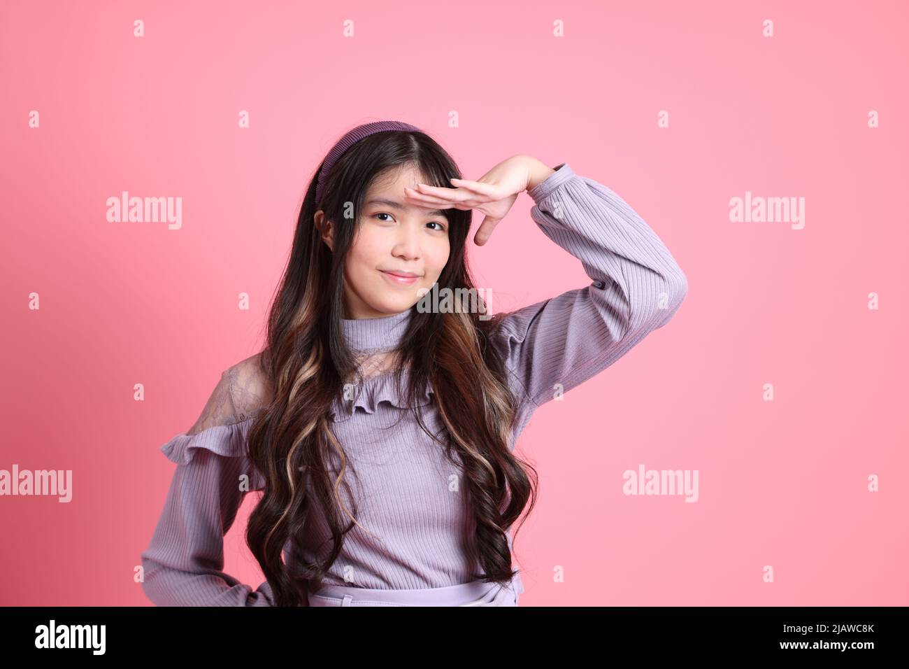 The cute young Asian woman with preppy dressed standing on the pink ...