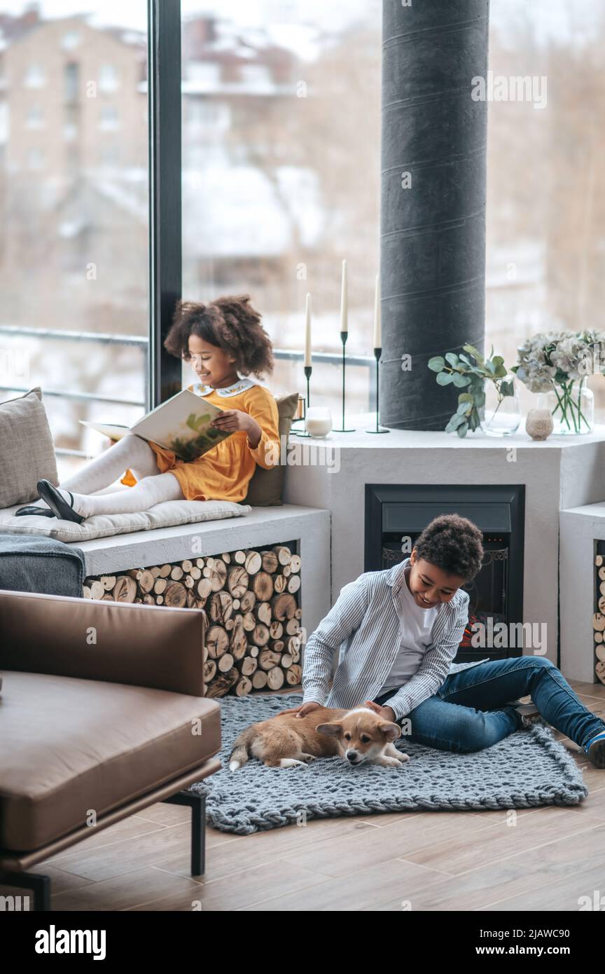 Siblings having peaceful time together at home Stock Photo - Alamy