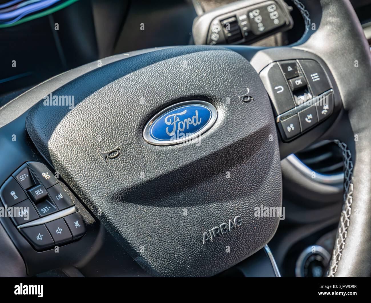 Close up detail with the logo of Ford company car on a steering wheel ...