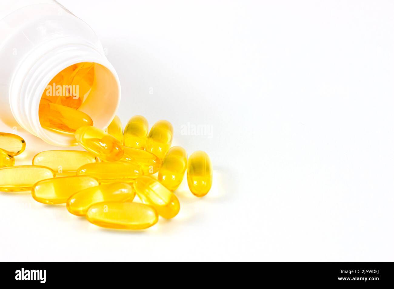 Bright yellow oval pills with fish oil (omega-3 vitamin) in the medical ...