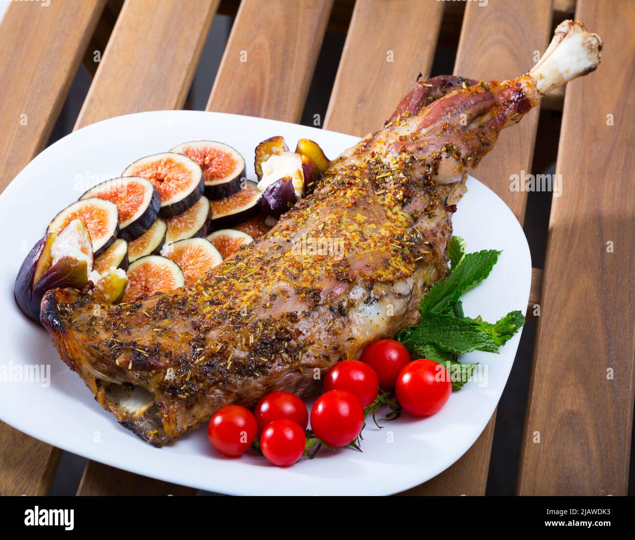 Baked shoulder of mutton with figs, tomatoes, soft cheese Stock Photo ...