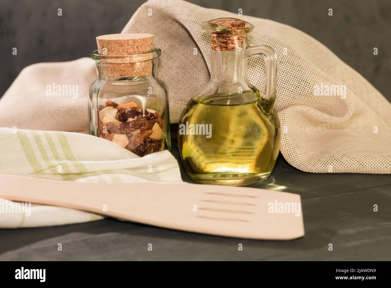 Dry spices and oil on the table. Linseed oil with kitchen utensils on ...