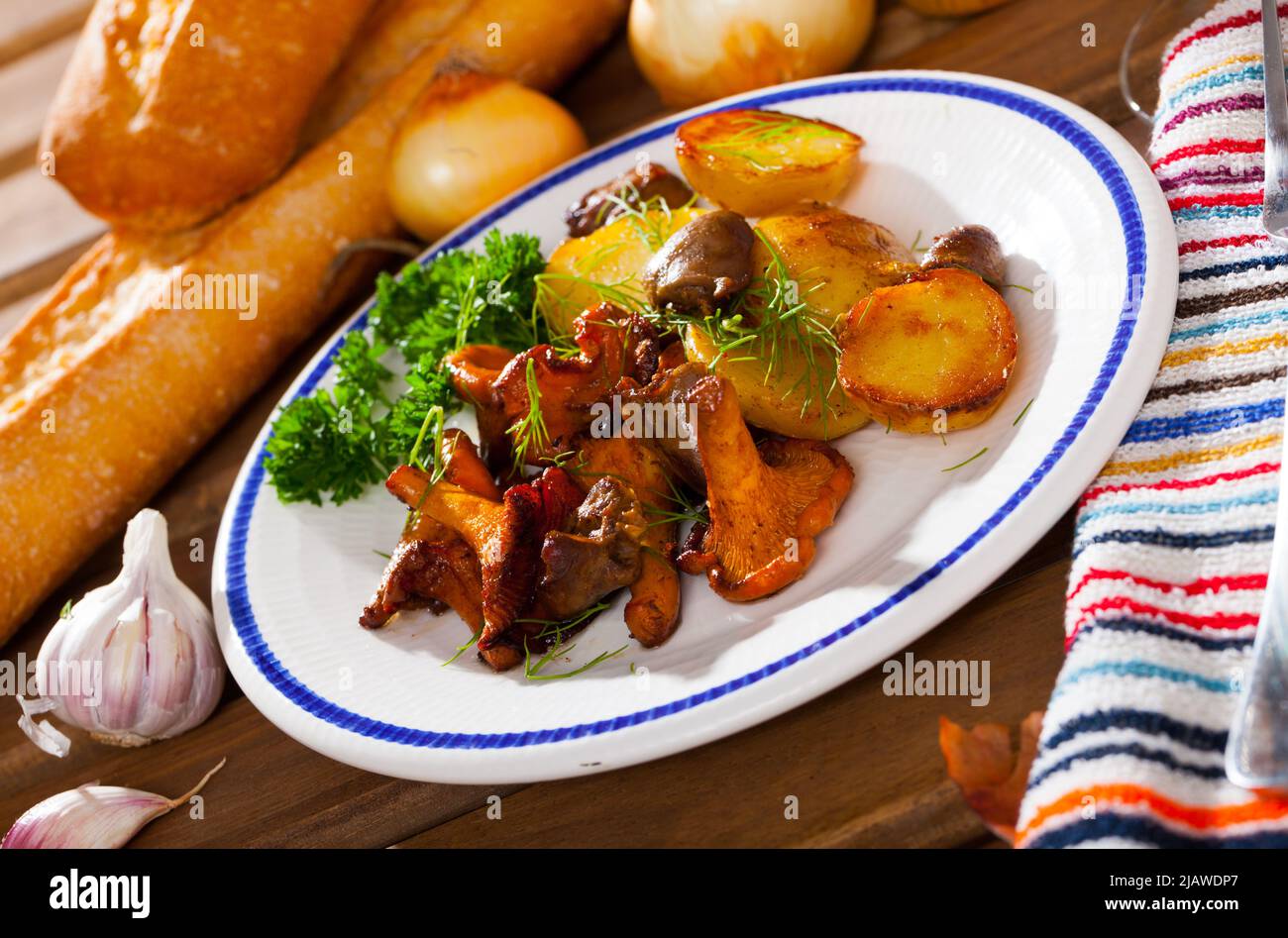 Fried girolles with potatoes and chicken hearts Stock Photo - Alamy