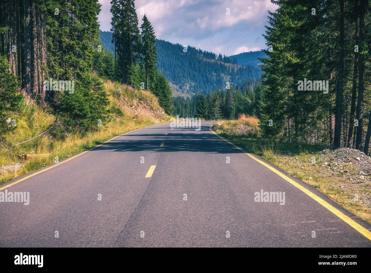 Mountain road. Landscape with rocks, sunny sky with clouds and ...